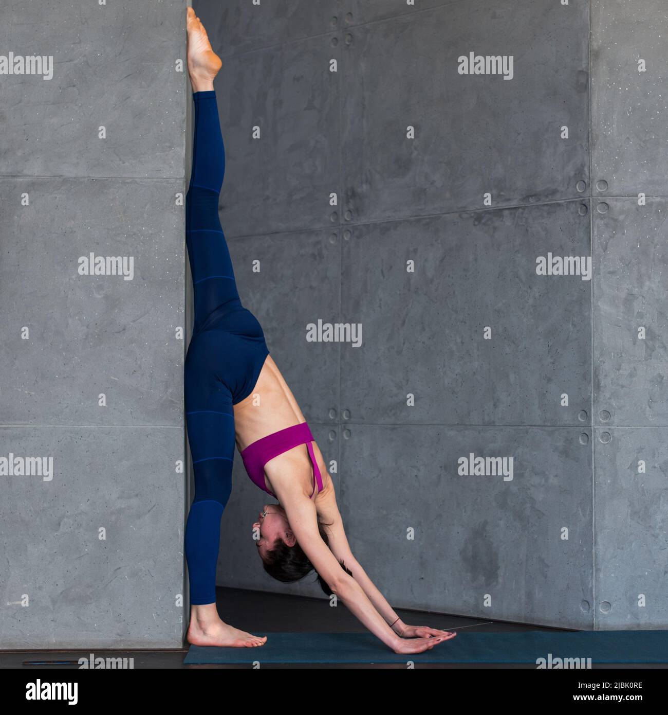 Professional gymnast doing warming-up stretching exercise performing ...