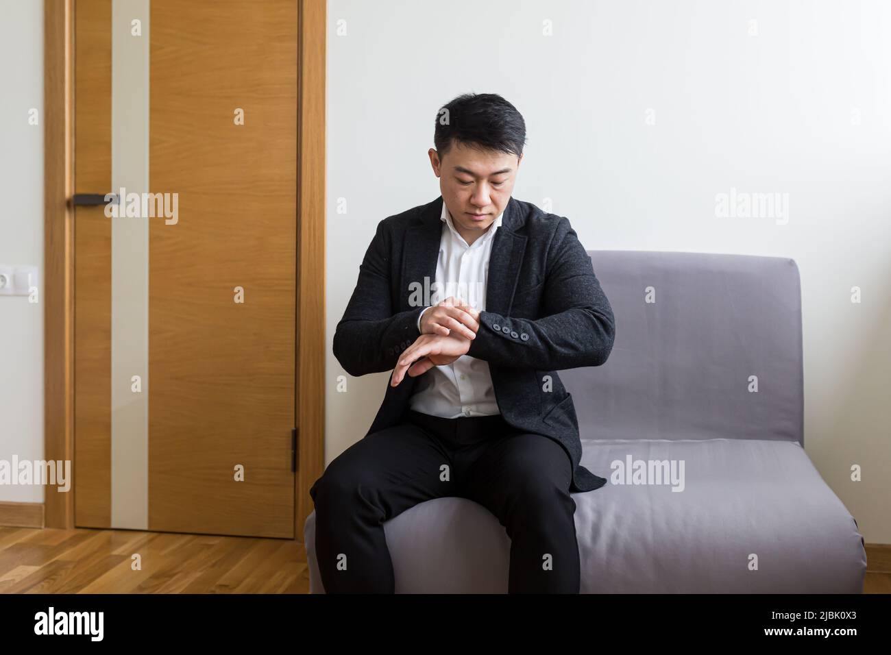 Young successful Asian man, waiting for a job interview, in the waiting ...