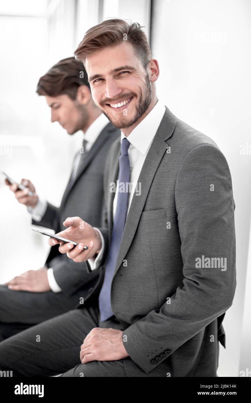 close up. successful employees with smartphones sitting in the office ...