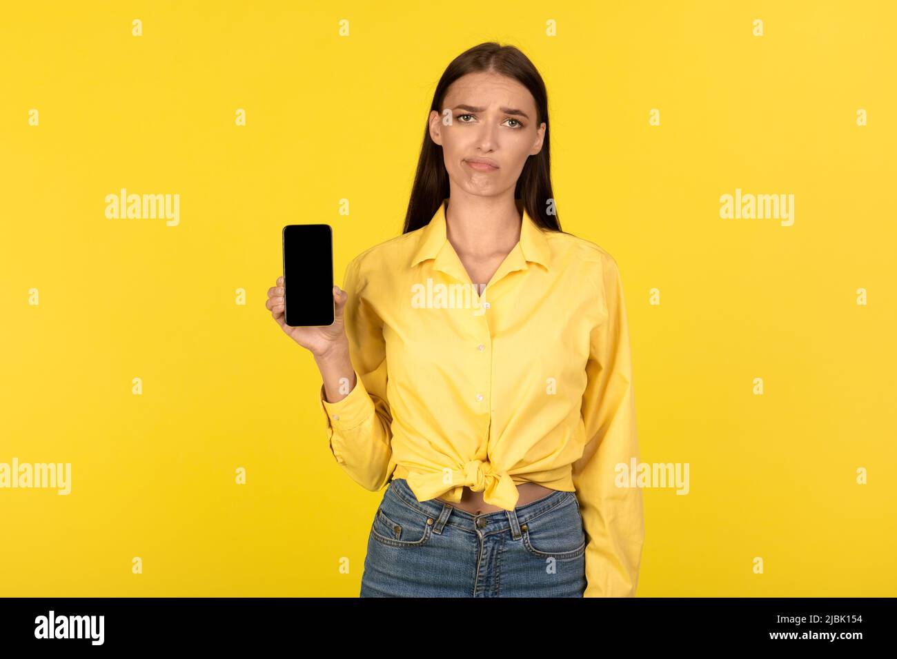 Discontented Millennial Woman Showing Cellphone With Blank Screen ...