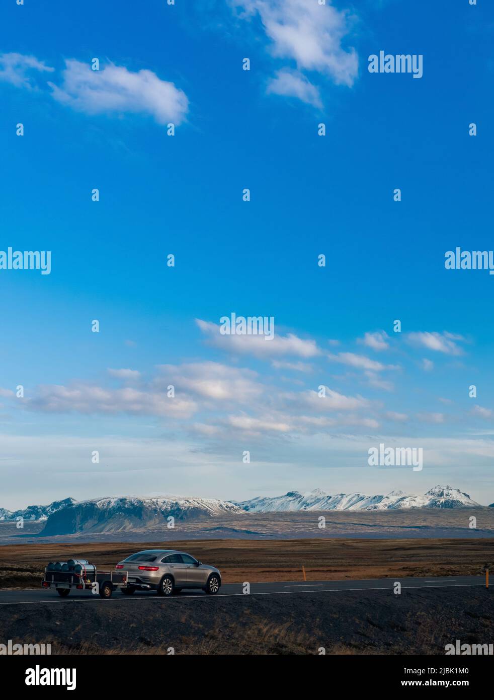 Car with trailer over the straight Iceland road Stock Photo - Alamy
