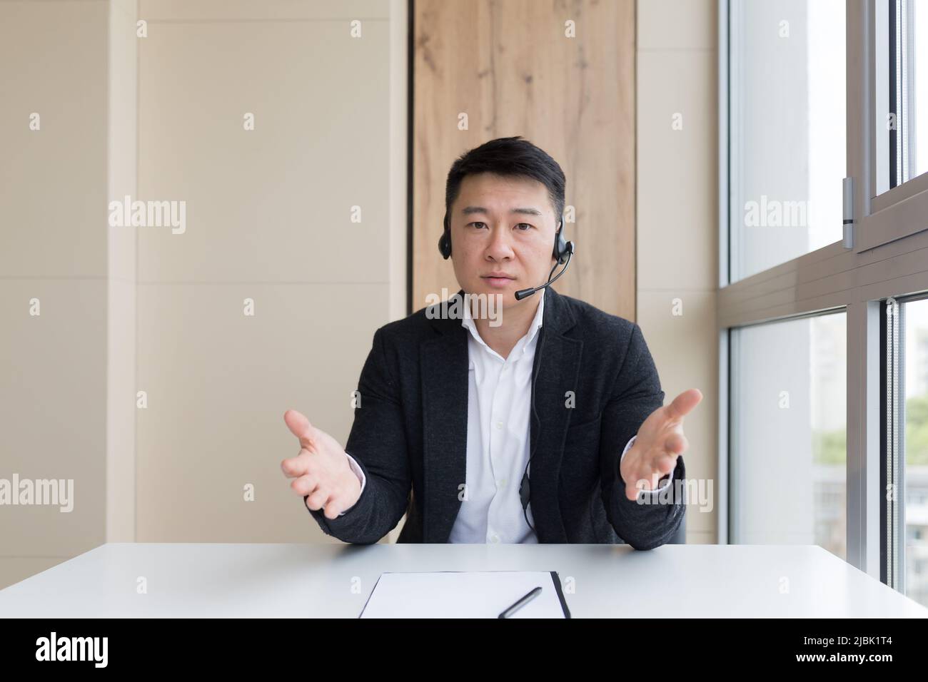 Asia man speaking to camera hi-res stock photography and images - Alamy