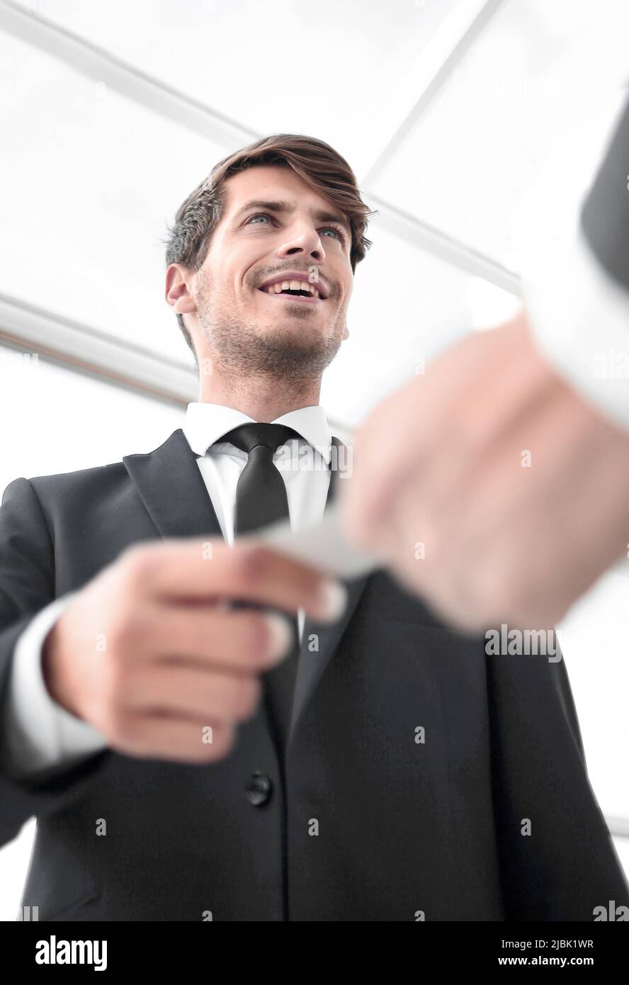 bottom view.business hands over his business card Stock Photo - Alamy