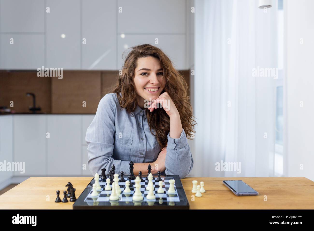Woman board game looking at camera hi-res stock photography and images ...