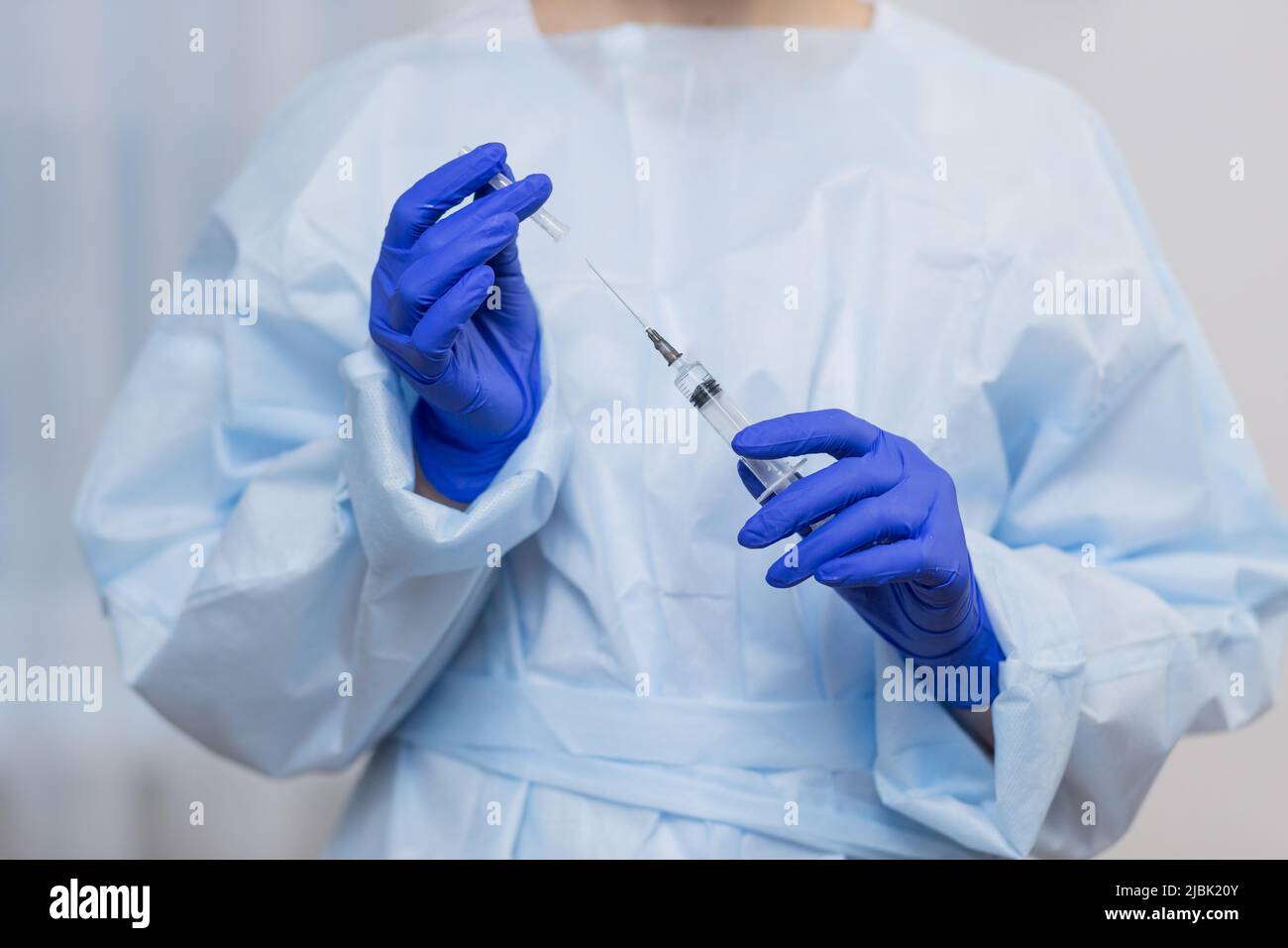 Close Up Of Female Doctors Hands In Blue Medical Gloves Holding A