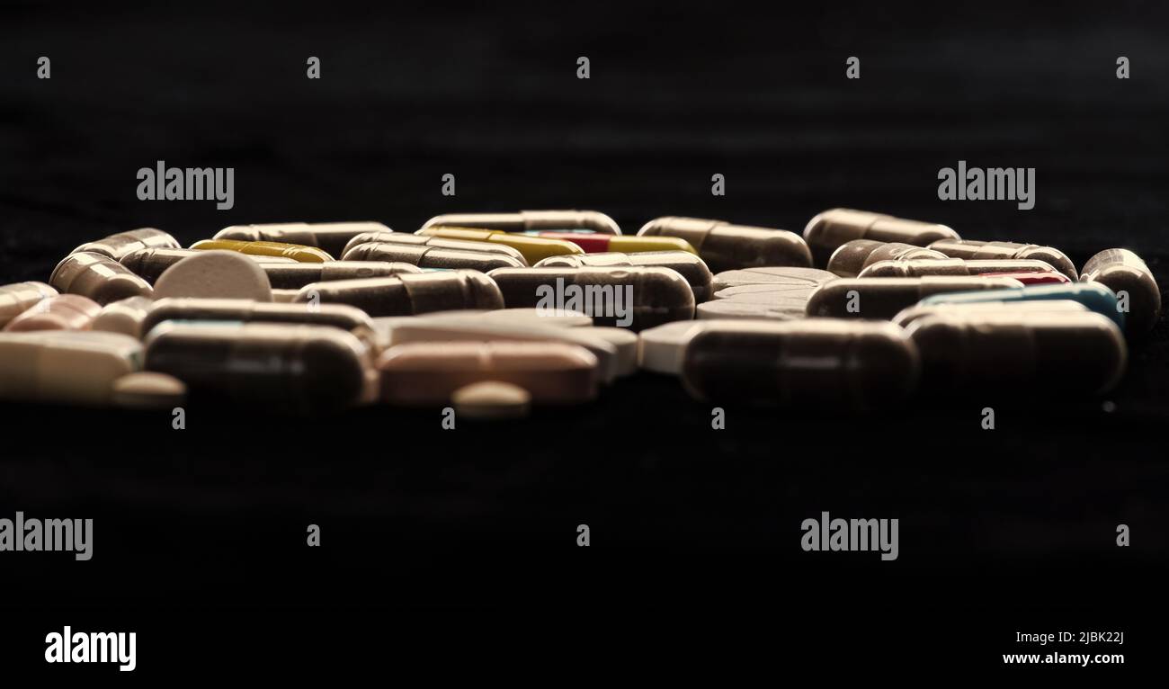 Starch capsule pills and tablets dark background, drugs Stock Photo - Alamy