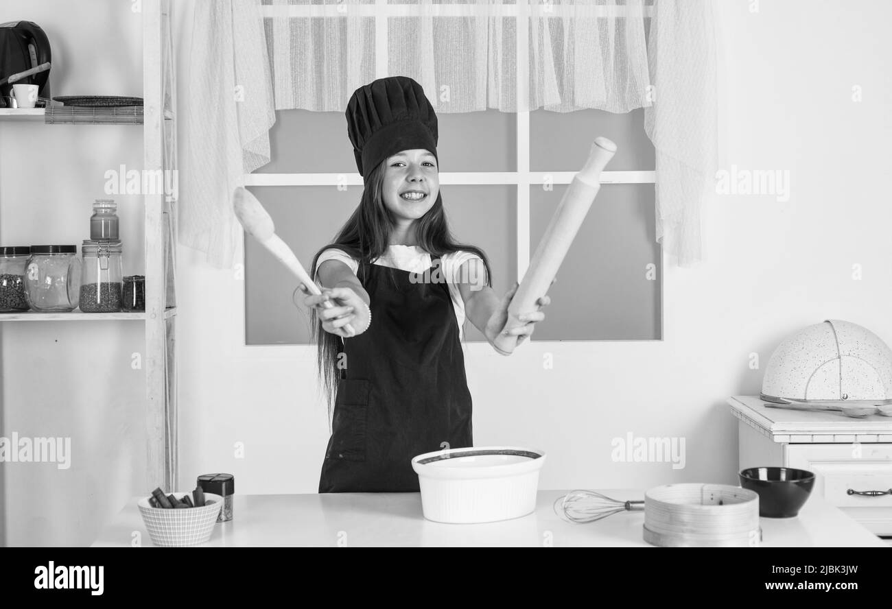 child use wooden spoon and rolling spoon, cuisine Stock Photo - Alamy