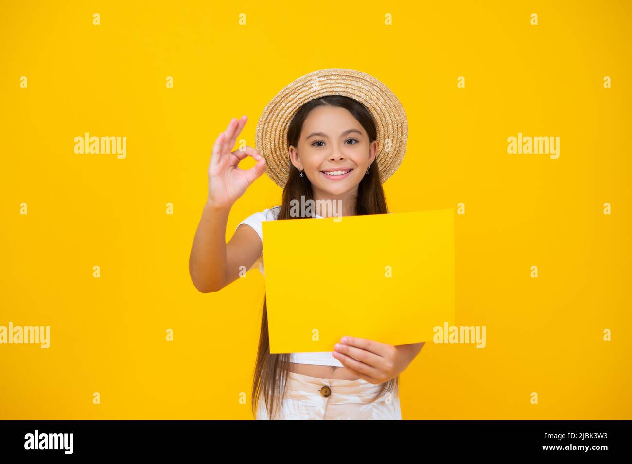 happy teen girl hold empty advertisement paper with copy space on ...