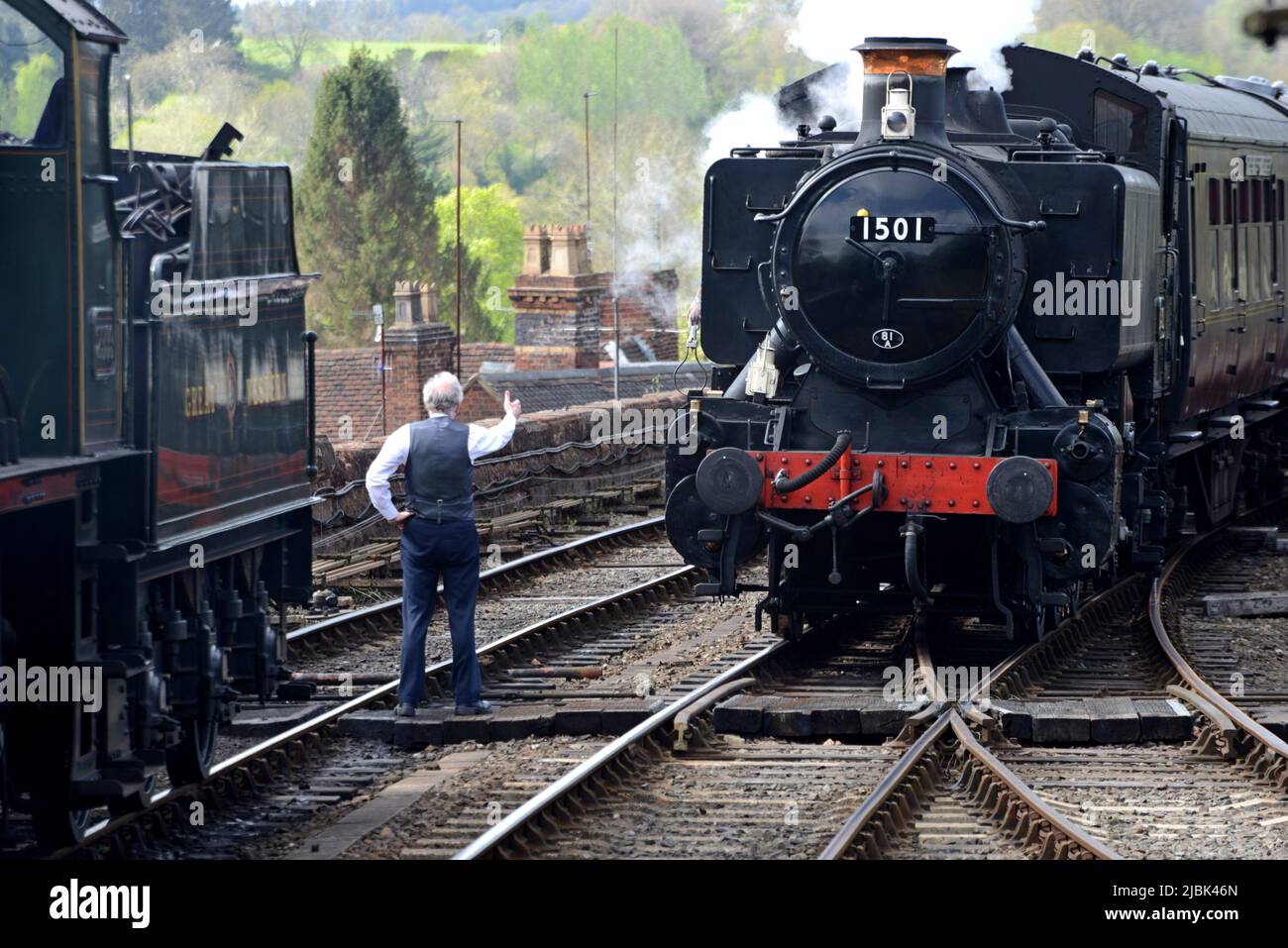 A signalman waits in the centre of the track to exchange tokens with ...