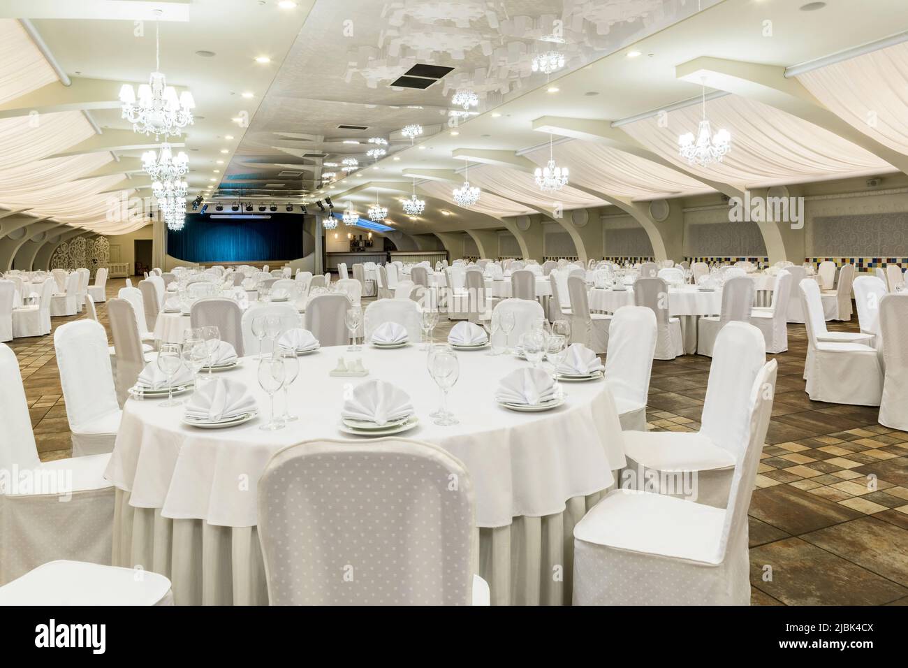 Elegant banquet hall interior prepared for feast with served tables and ...