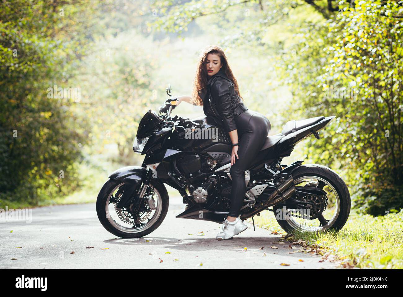 Portrait Of A Beautiful Young Woman Sitting On A Motorcycle Riding A