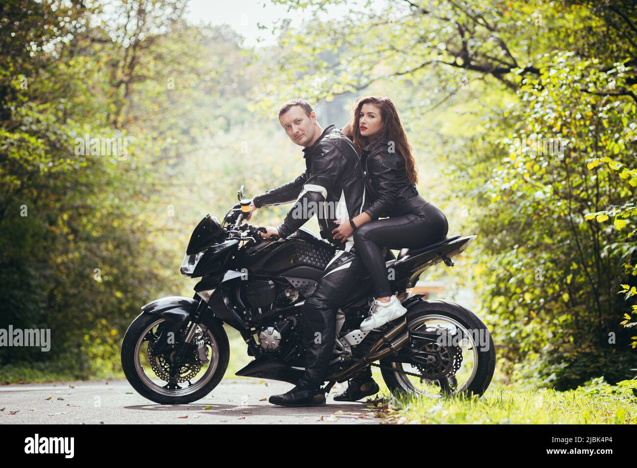 Handsome young man and beautiful young girl, couple sitting on a ...