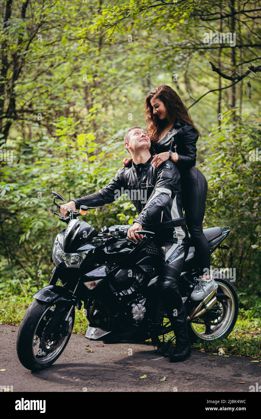 Handsome young man and beautiful young girl, couple sitting on a ...