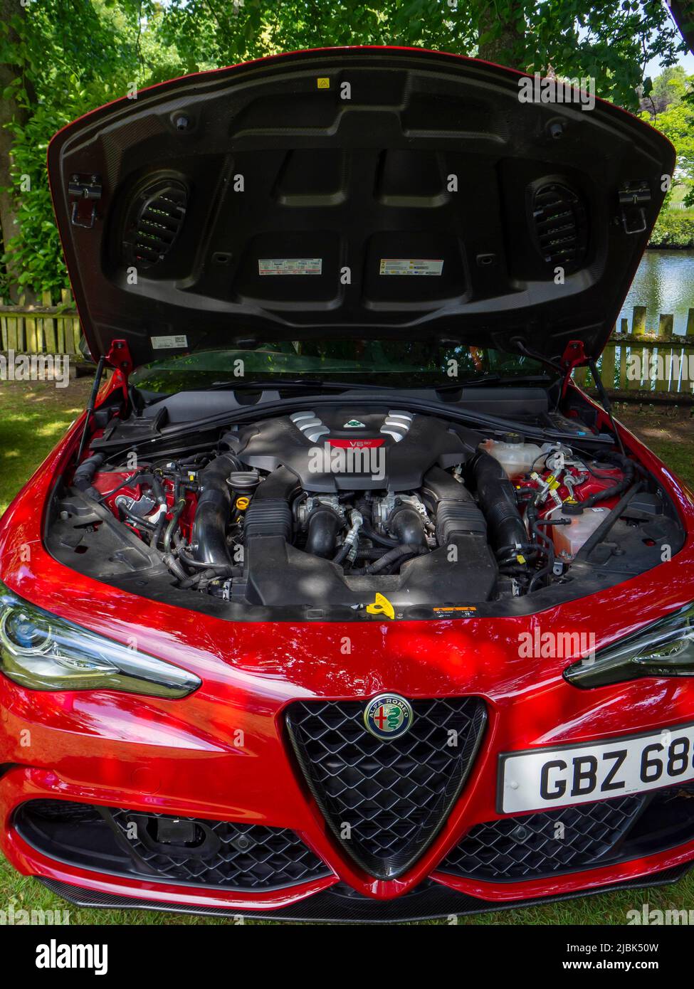 Alfa Romeo with its engine on display Stock Photo - Alamy