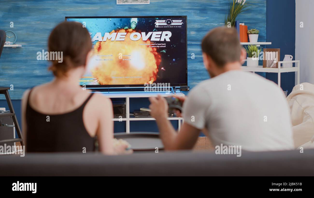 Young woman disappointed because of gamer boyfriend losing online game ...