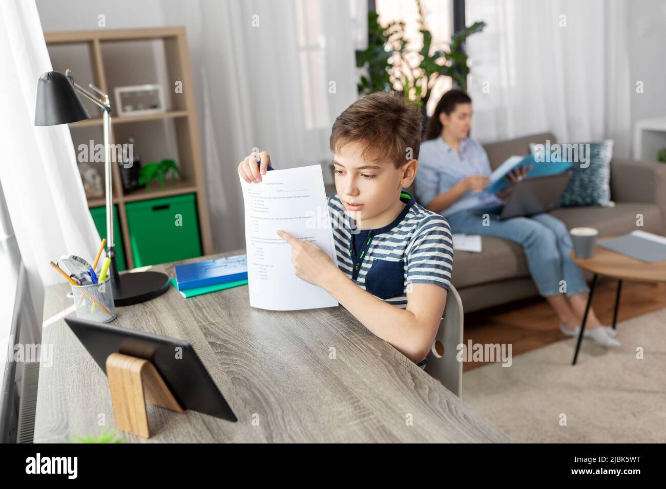 student boy with tablet computer learning at home Stock Photo - Alamy