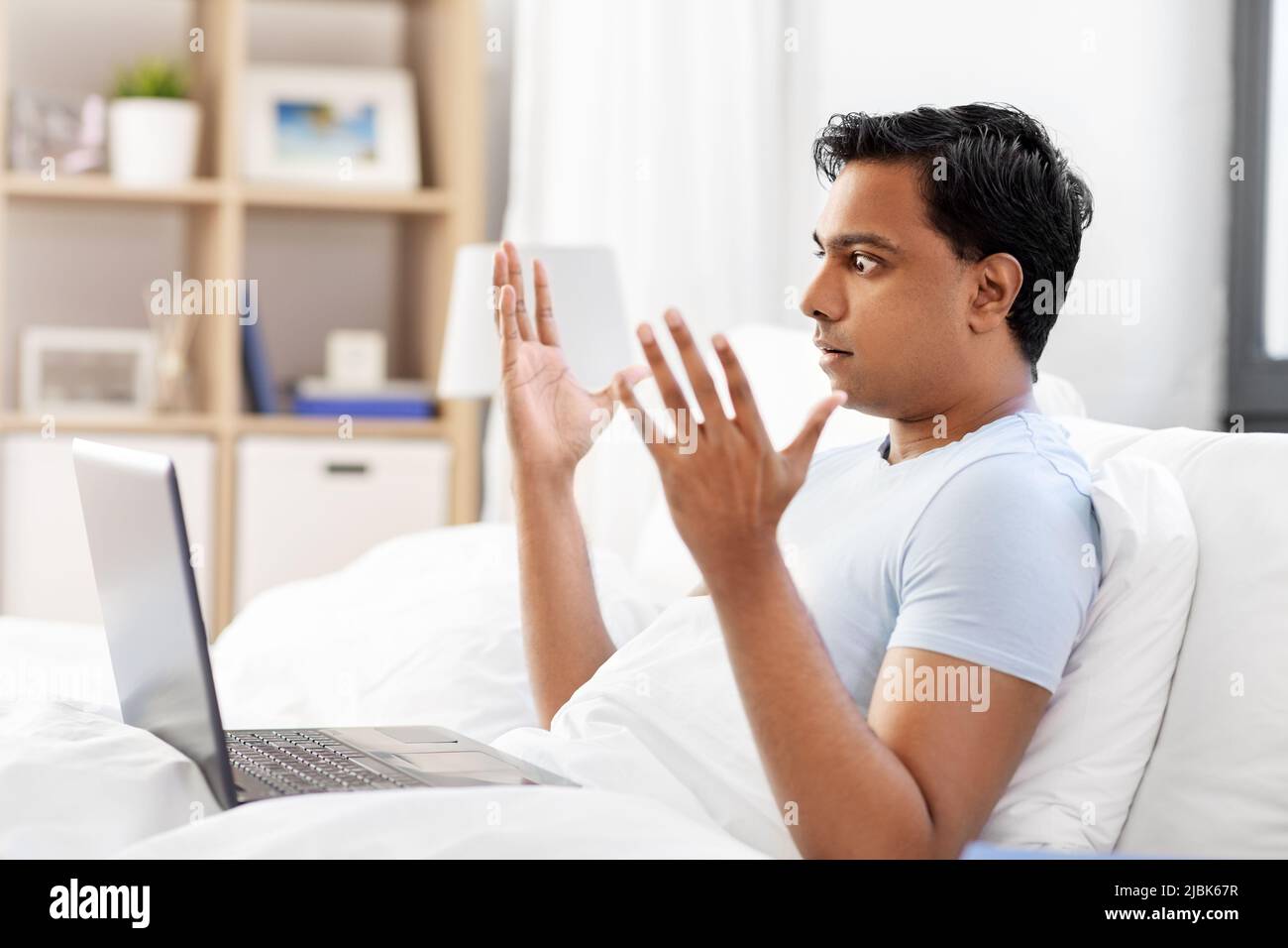 stressed indian man with laptop in bed at home Stock Photo - Alamy