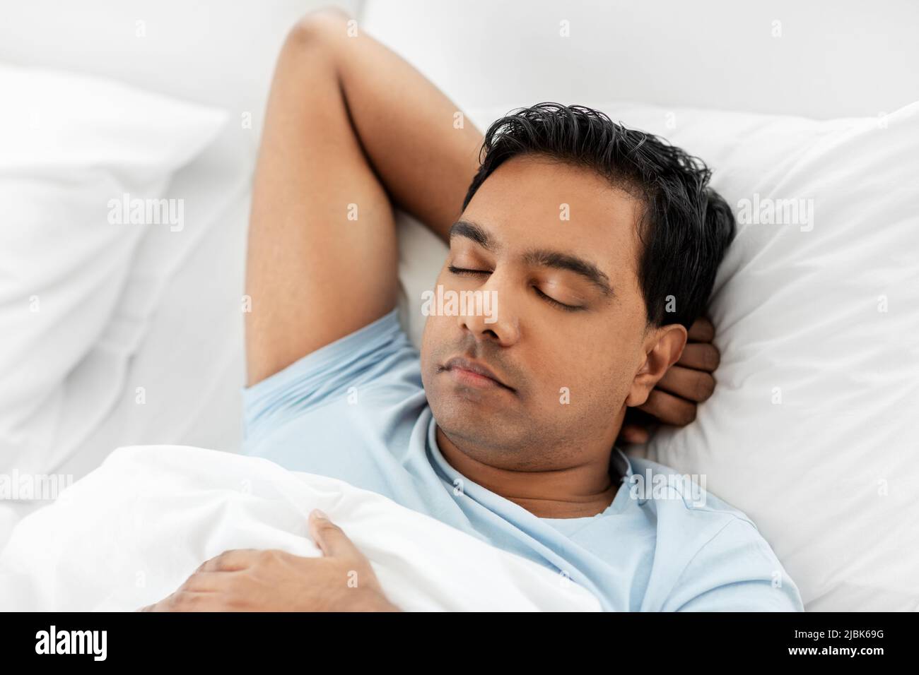 Indian man sleeping in bed hi-res stock photography and images - Alamy