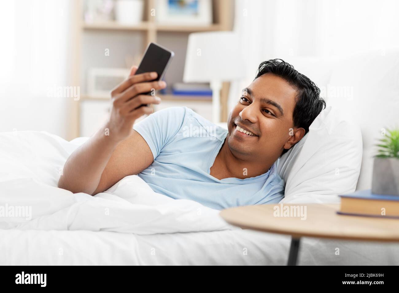 Indian man smartphone in bed hi-res stock photography and images - Alamy
