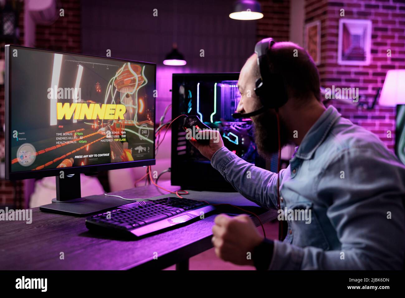 Content creator winning action video games on computer, playing online ...