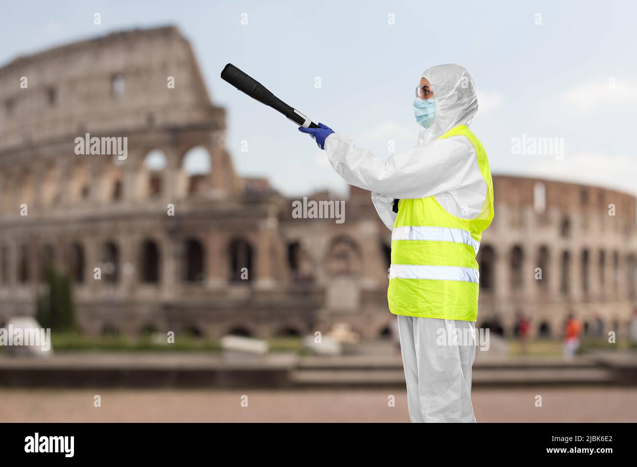 sanitation worker in hazmat with pressure washer Stock Photo - Alamy