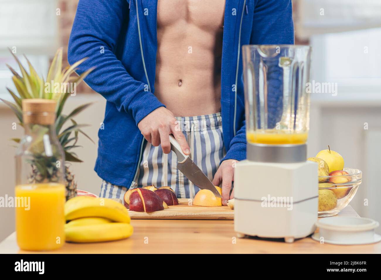 Portrait of a young handsome pumped up muscular sports man standing in ...