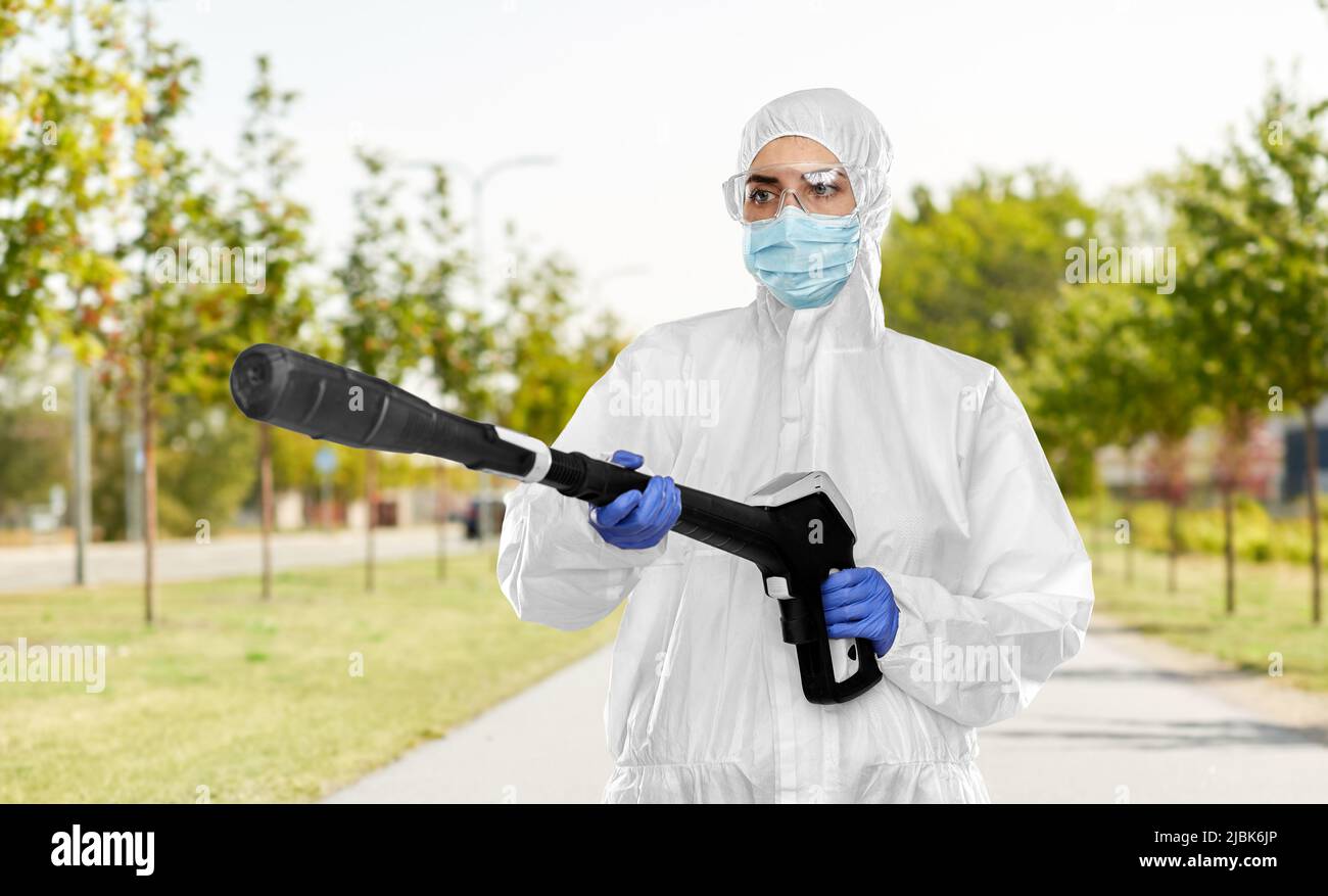 sanitation worker in hazmat with pressure washer Stock Photo - Alamy