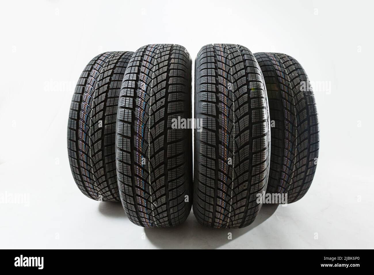 four black tires isolated on white background Stock Photo - Alamy