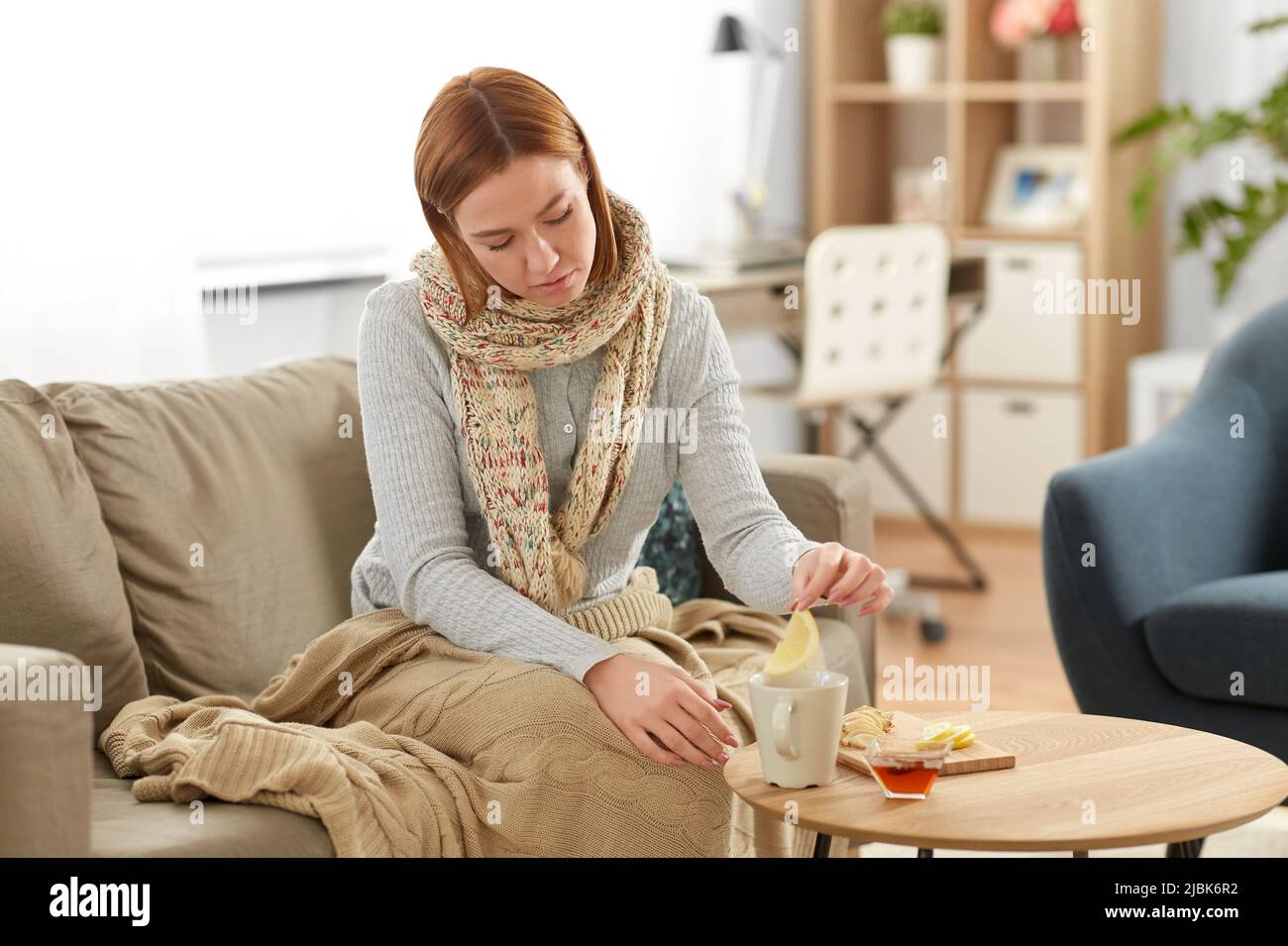 sad sick young woman drinking lemon tea at home Stock Photo - Alamy