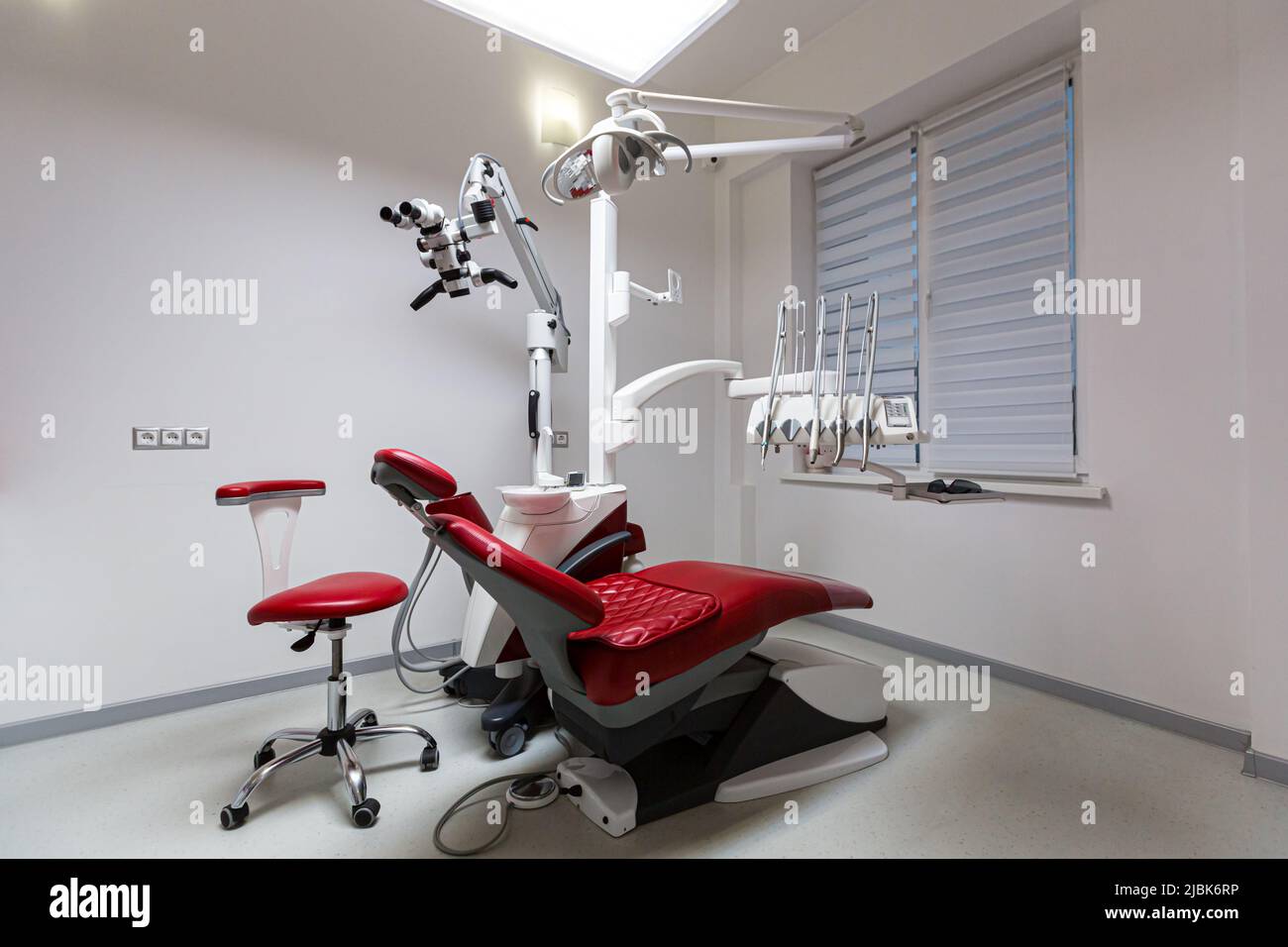 Dental office, red dental chair with tools for dental treatment Stock ...