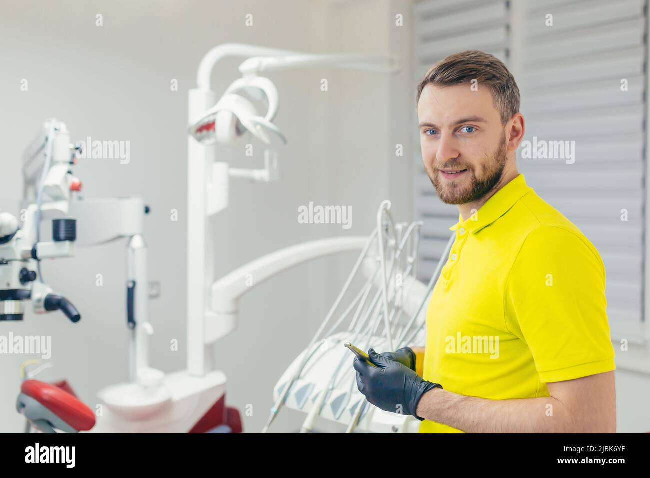 Dentist in yellow gloves black hi-res stock photography and images - Alamy