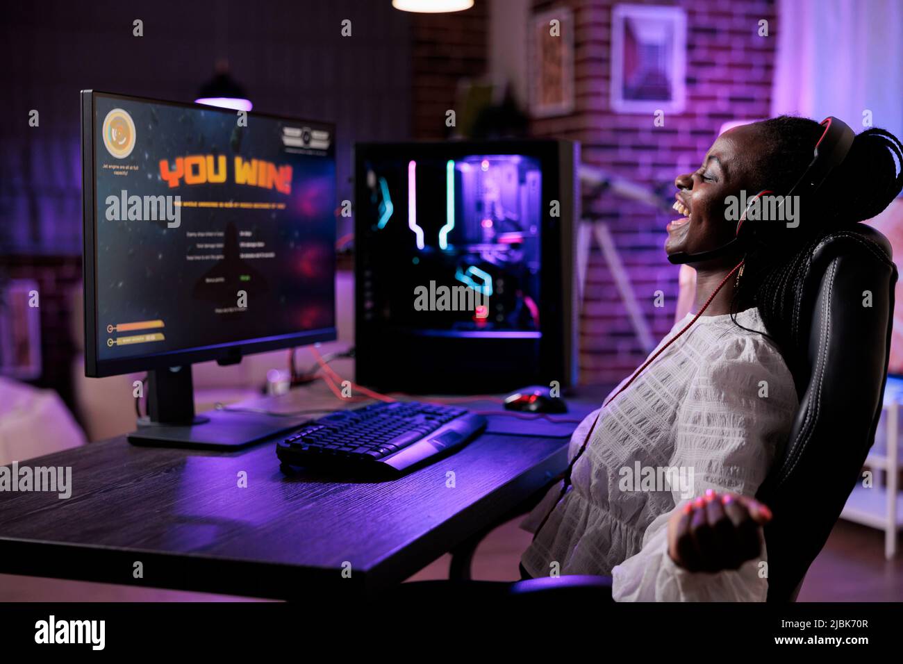 Female player celebrating successful video games online win, using ...