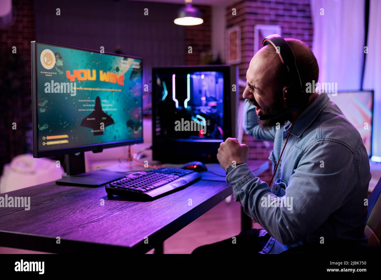 Modern adult celebrating video games competition win on live stream ...