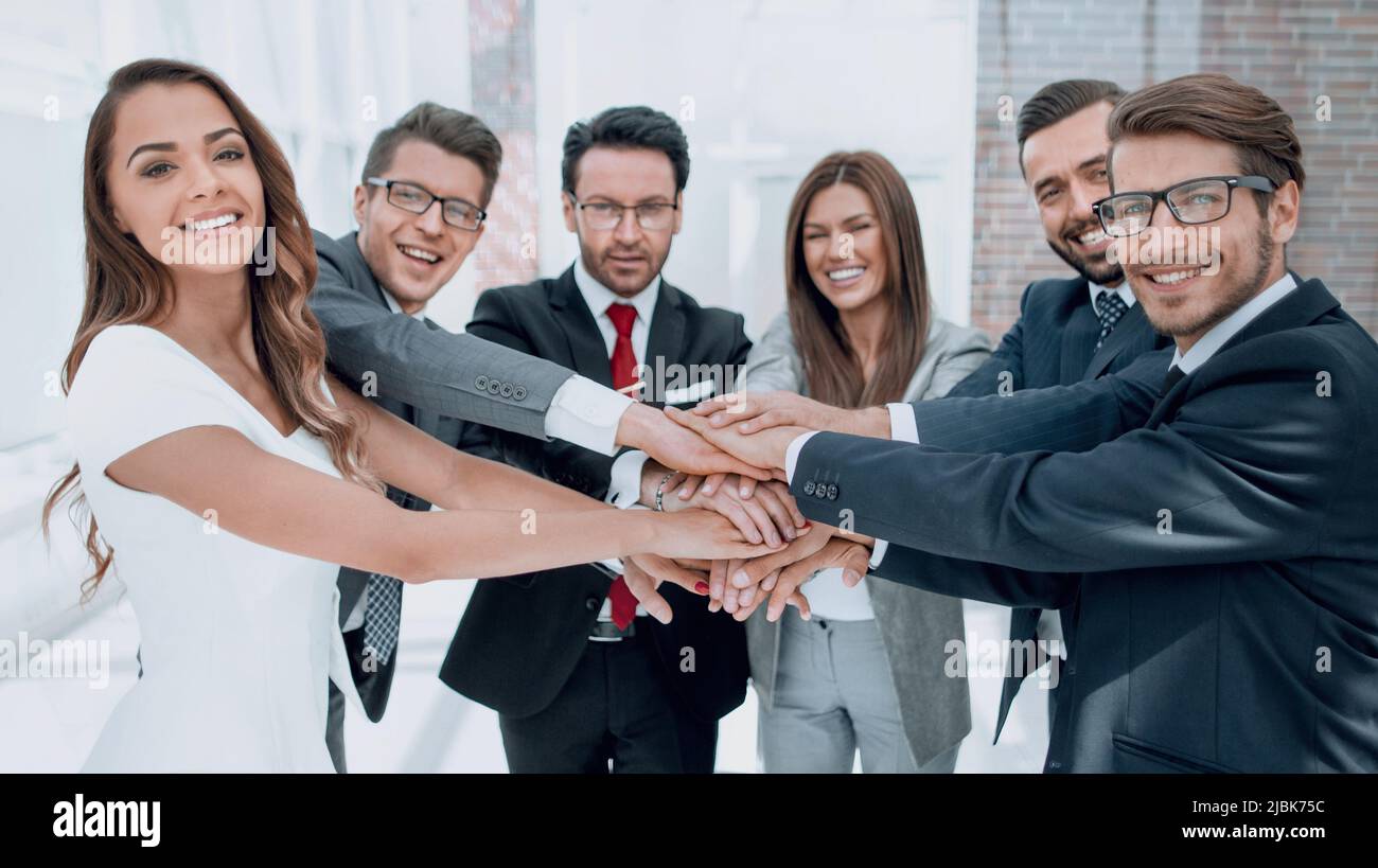 happy business team joining hands together Stock Photo - Alamy
