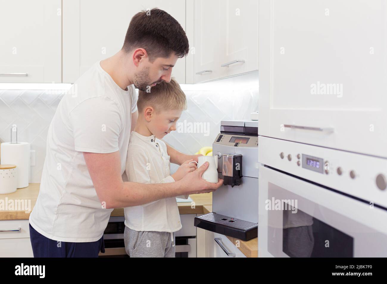 Father and son cook together in the kitchen at home cocoa in home ...