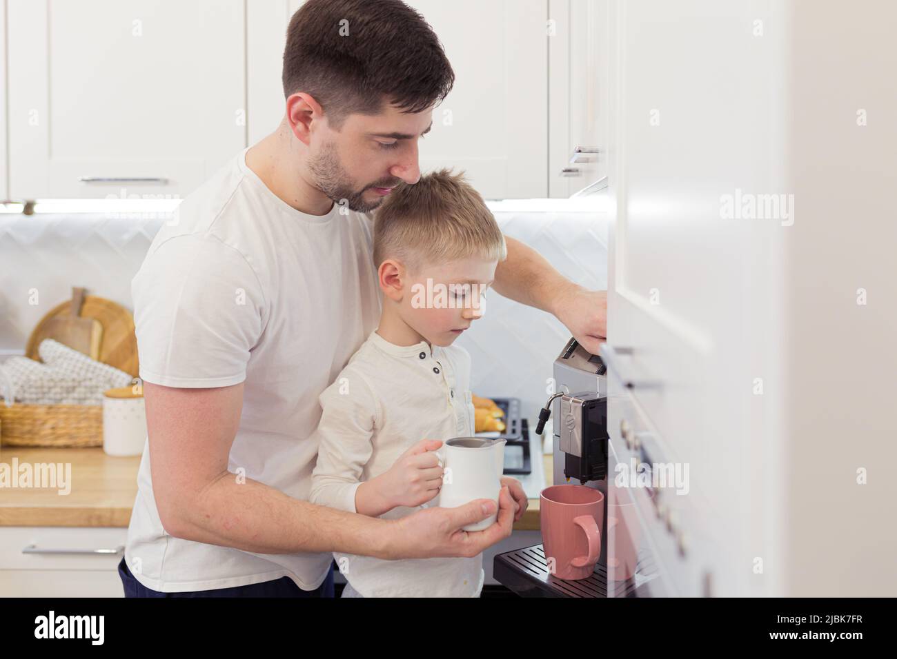 Father and son cook together in the kitchen at home cocoa in home ...