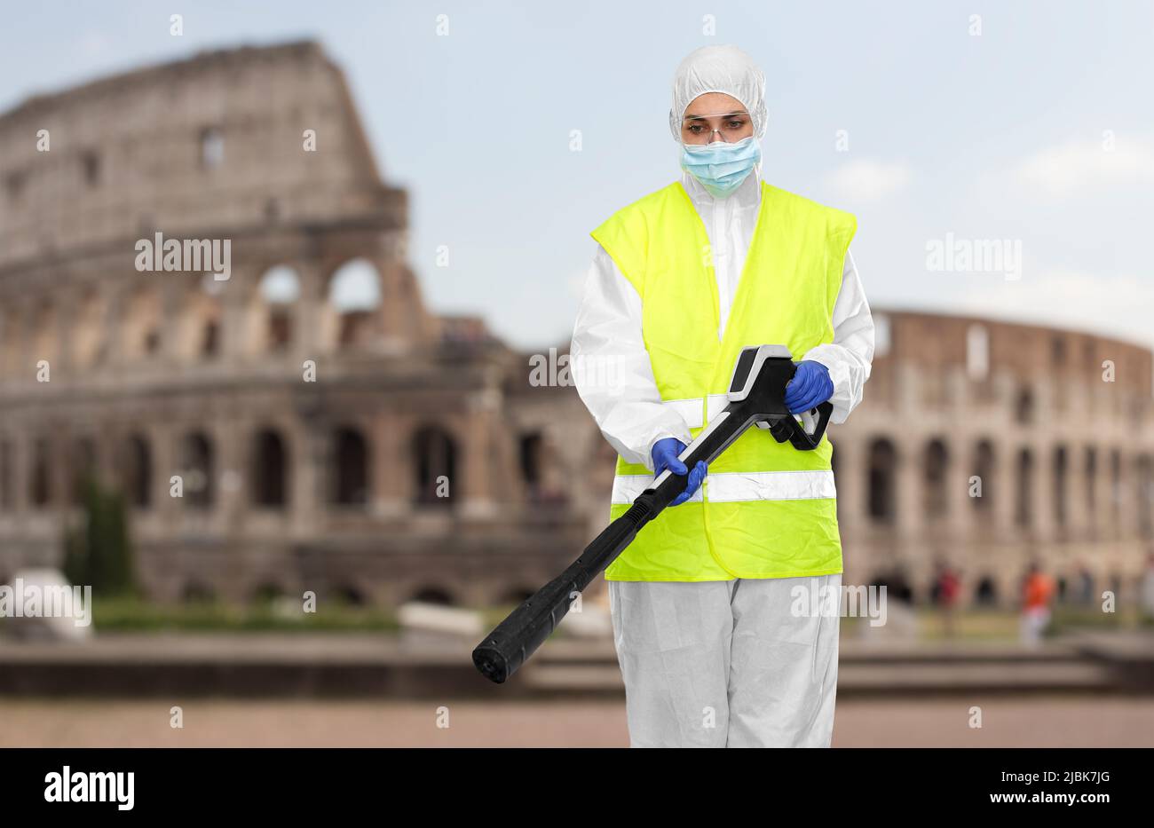 sanitation worker in hazmat with pressure washer Stock Photo - Alamy