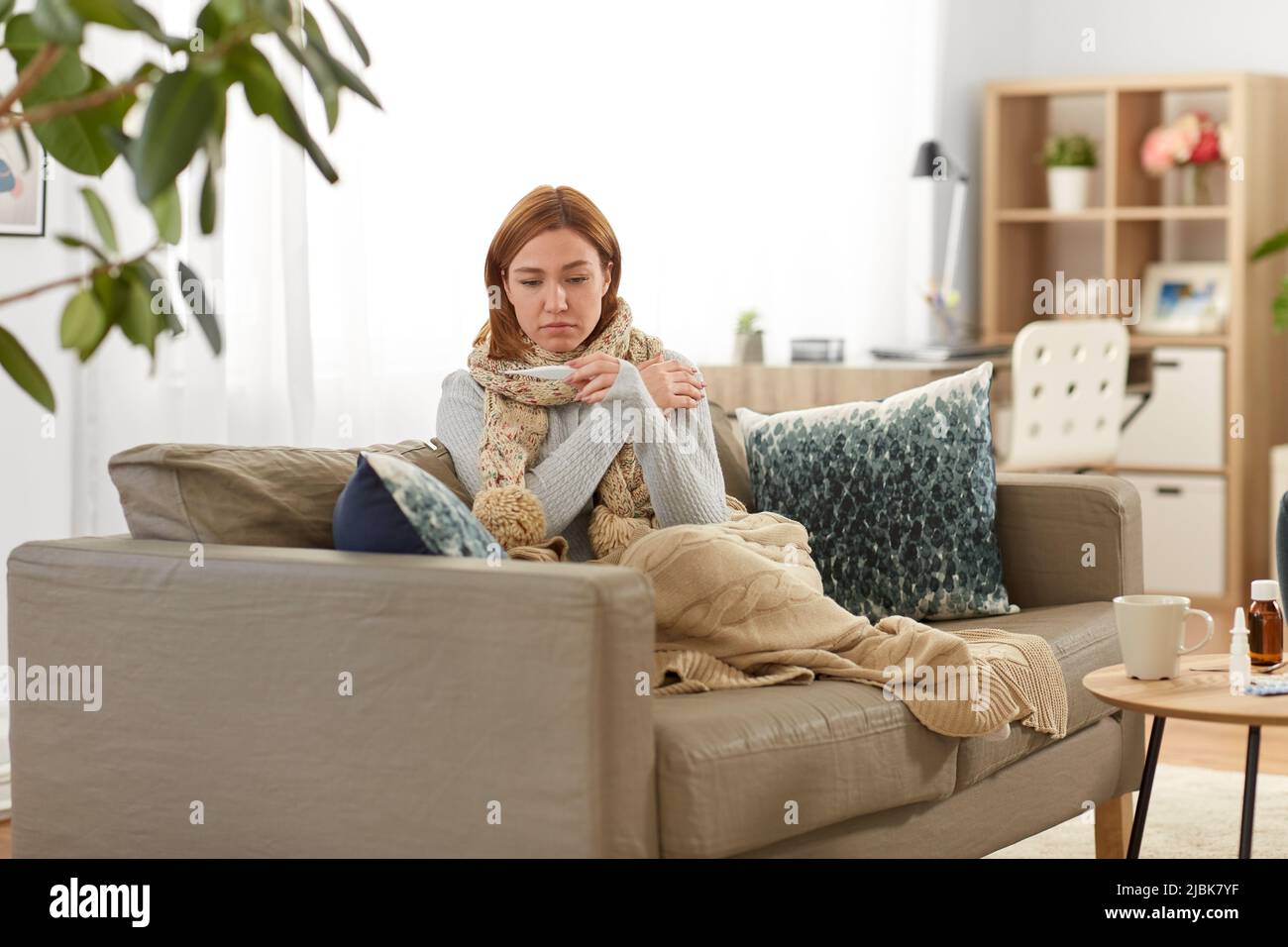 sick woman measuring temperature by thermometer Stock Photo - Alamy