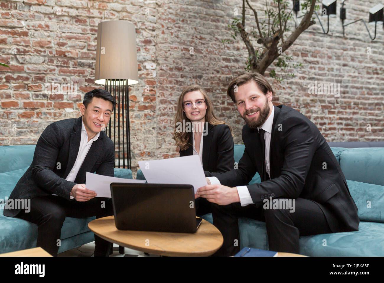 Employees brainstorm engaged in hi-res stock photography and images - Alamy