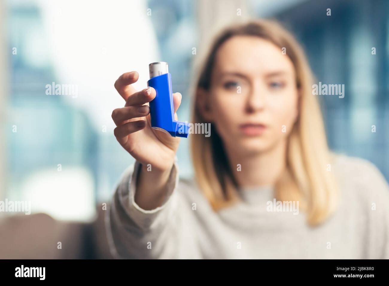 Beautiful girl while holding inhaler Stock Photo - Alamy