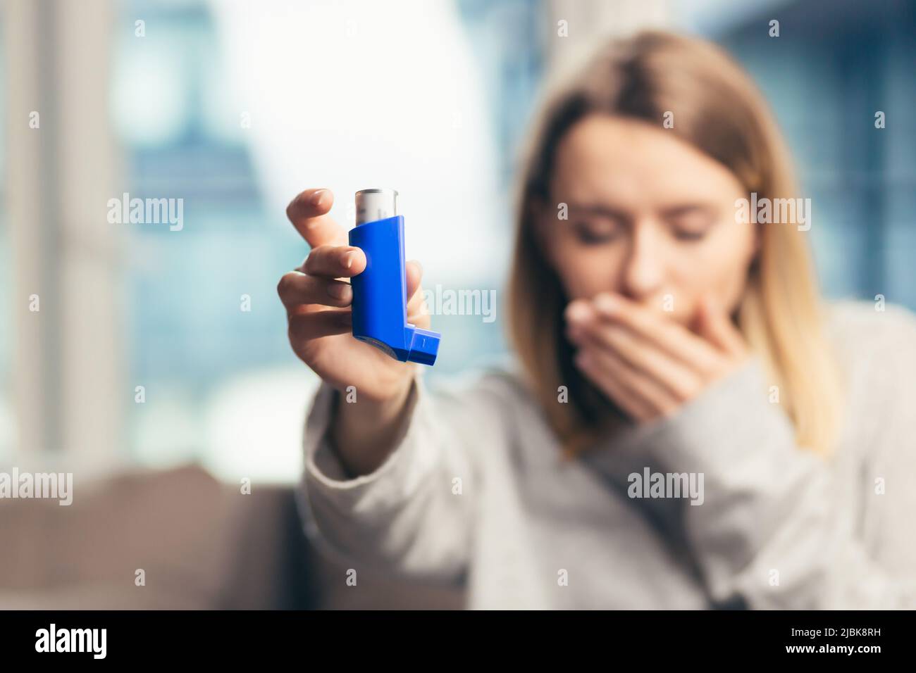 Beautiful girl while holding inhaler Stock Photo - Alamy
