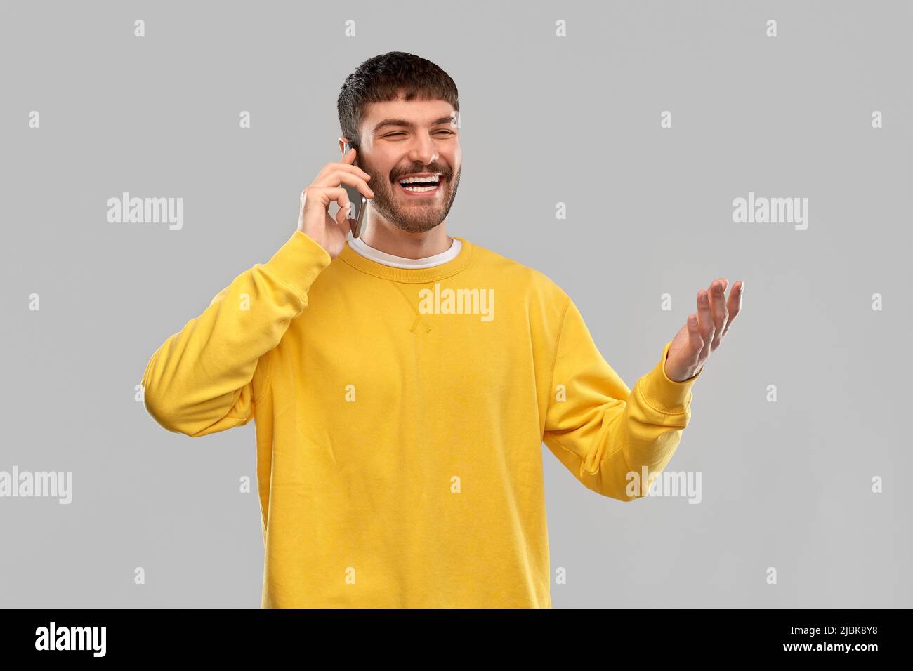 happy smiling young man calling on smartphone Stock Photo - Alamy