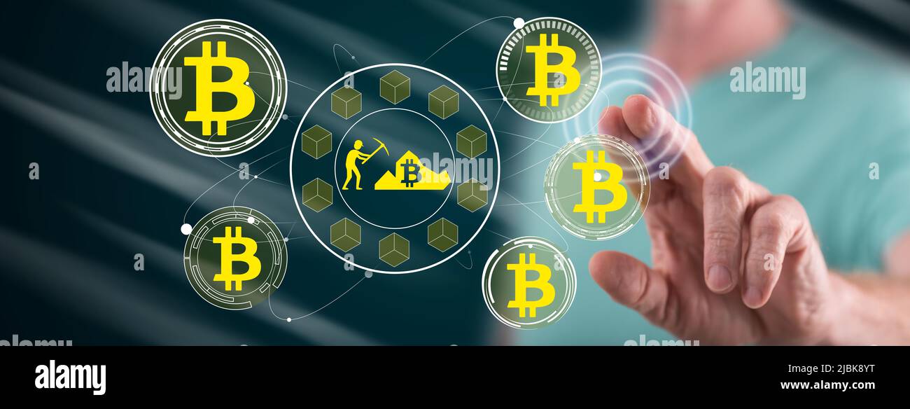 Man touching a bitcoin mining concept on a touch screen with his finger ...