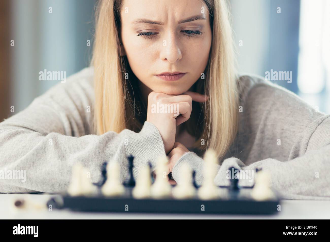Close Up Photo Portrait Of Young Beautiful Woman Playing Chess At Home