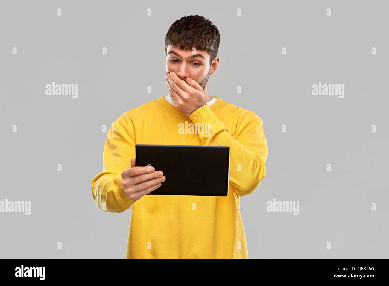 Shocked man tablet computer hi-res stock photography and images - Alamy