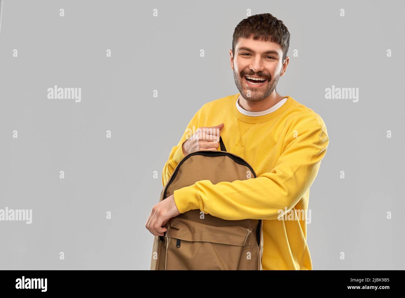 Portrait laughing man backpack hi-res stock photography and images - Alamy