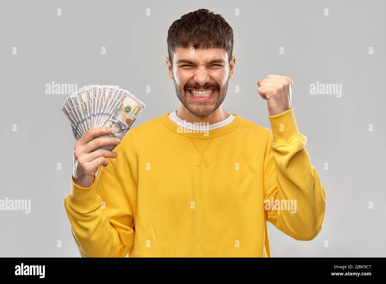 happy young man with money celebrating success Stock Photo - Alamy