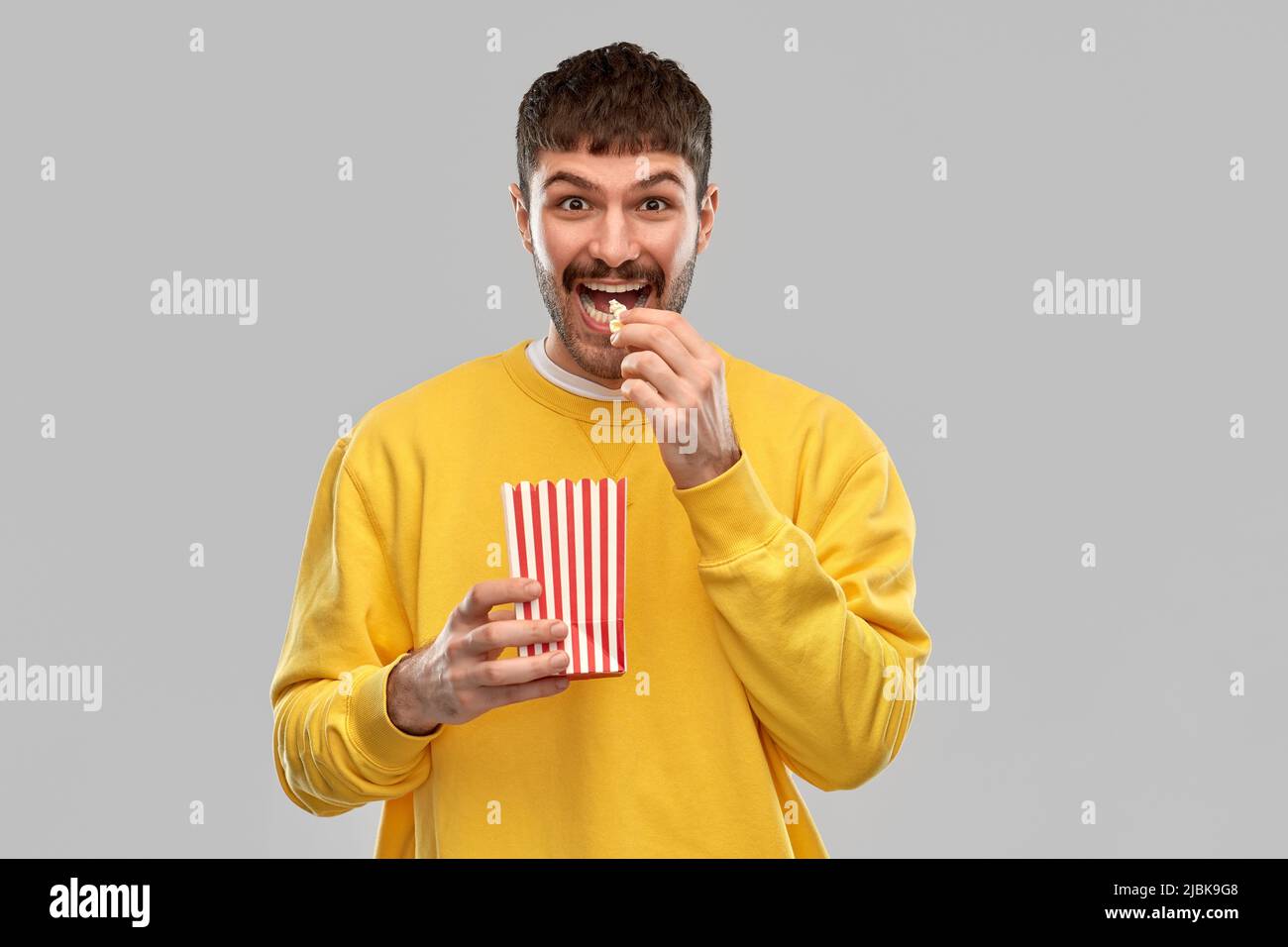 Man cinema laughing eating popcorn hi-res stock photography and images ...