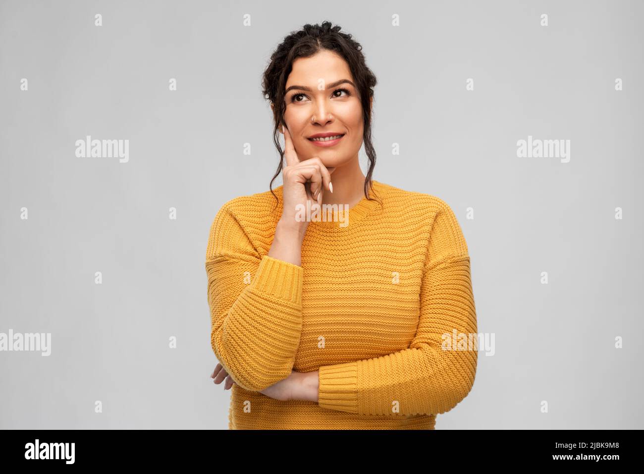thinking smiling young woman with pierced nose Stock Photo - Alamy