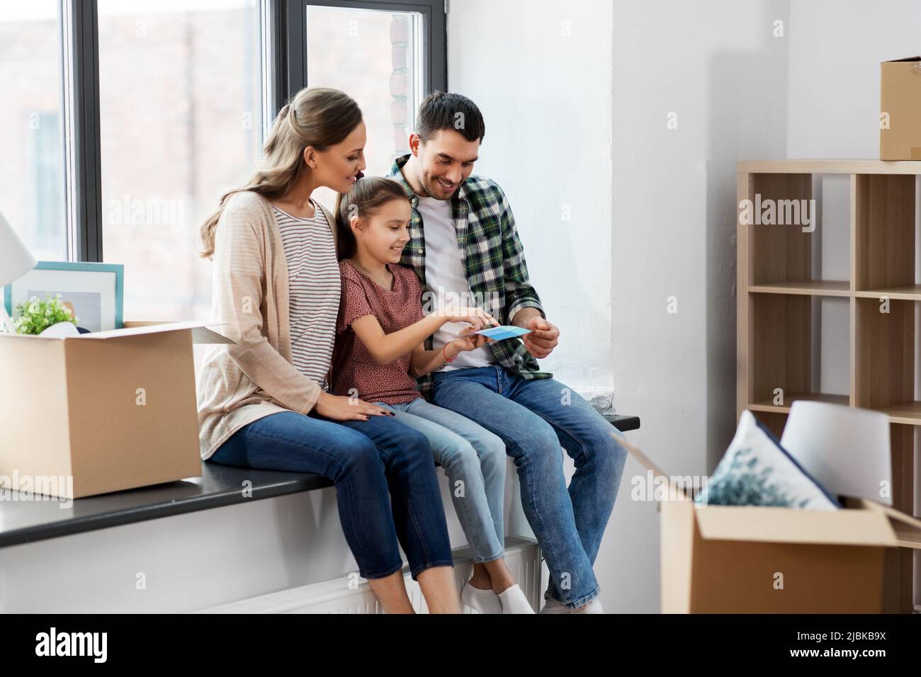 happy family with color palette moving to new home Stock Photo - Alamy